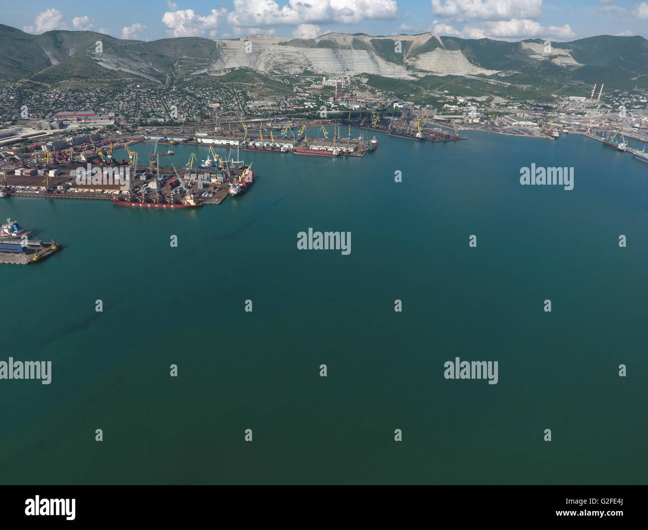 Industrial seaport, top view. Port cranes and cargo ships and barges ...