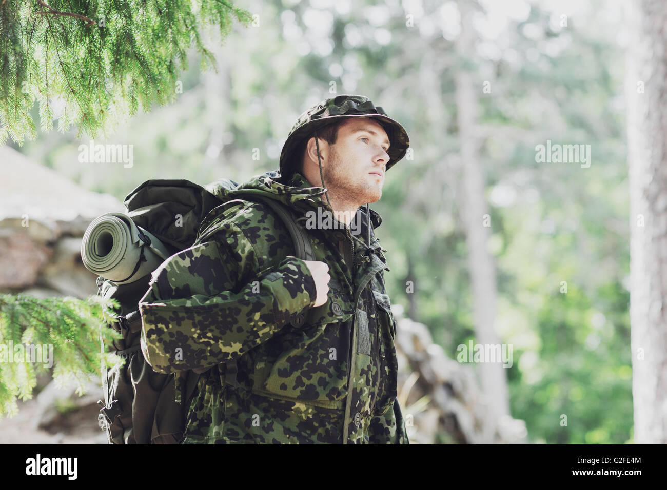 young soldier with backpack in forest Stock Photo - Alamy
