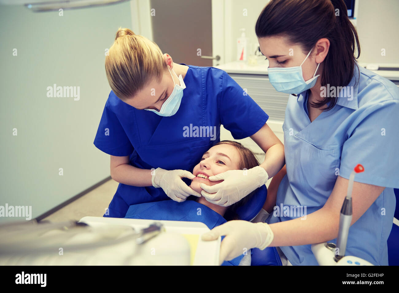 happy female dentist with patient girl at clinic Stock Photo - Alamy