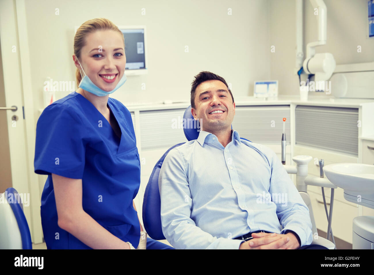 happy female dentist with man patient at clinic Stock Photo - Alamy