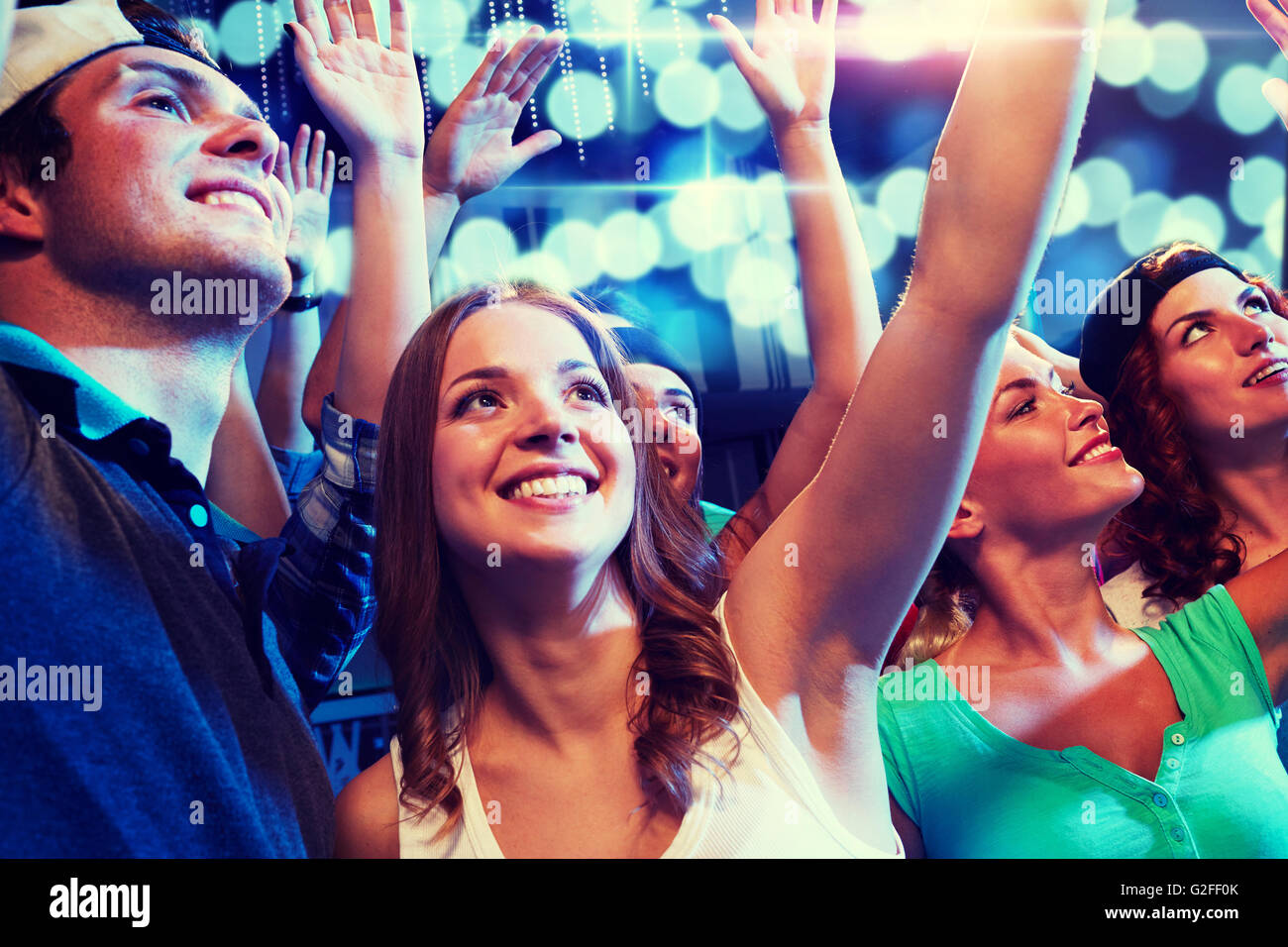 smiling friends at concert in club Stock Photo - Alamy