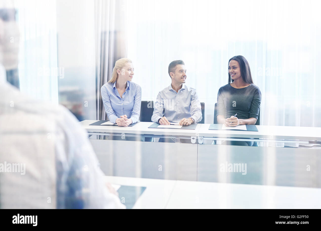 group of smiling businesspeople meeting in office Stock Photo - Alamy