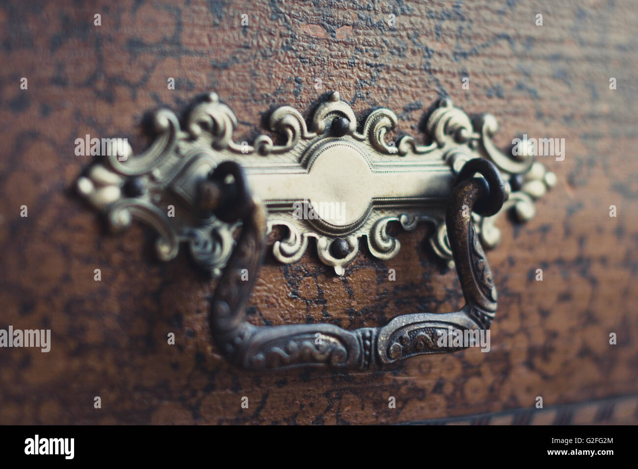 old ornate furniture handle - vintage filter Stock Photo - Alamy