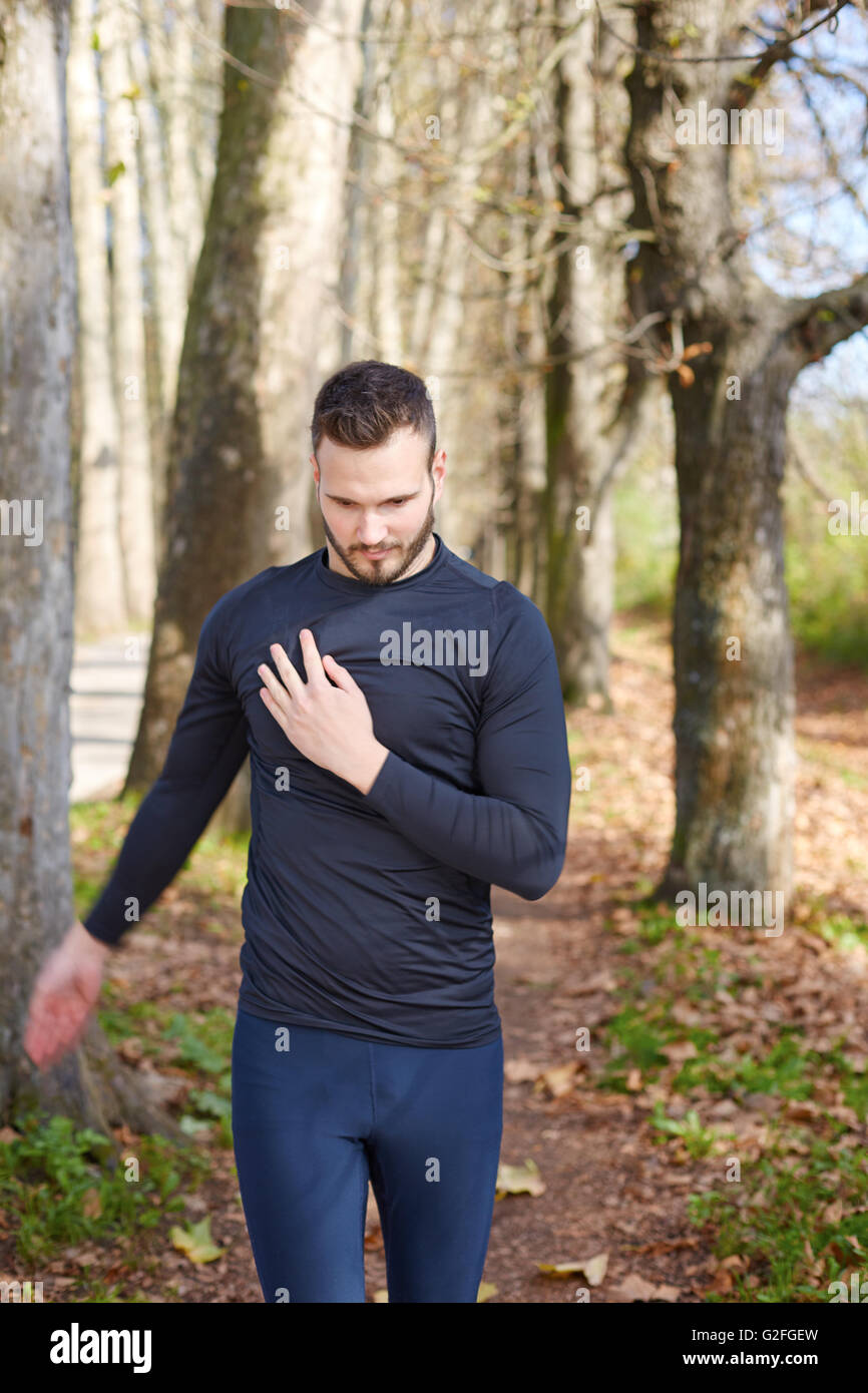 Runner doing stretching outside in autumn Stock Photo - Alamy