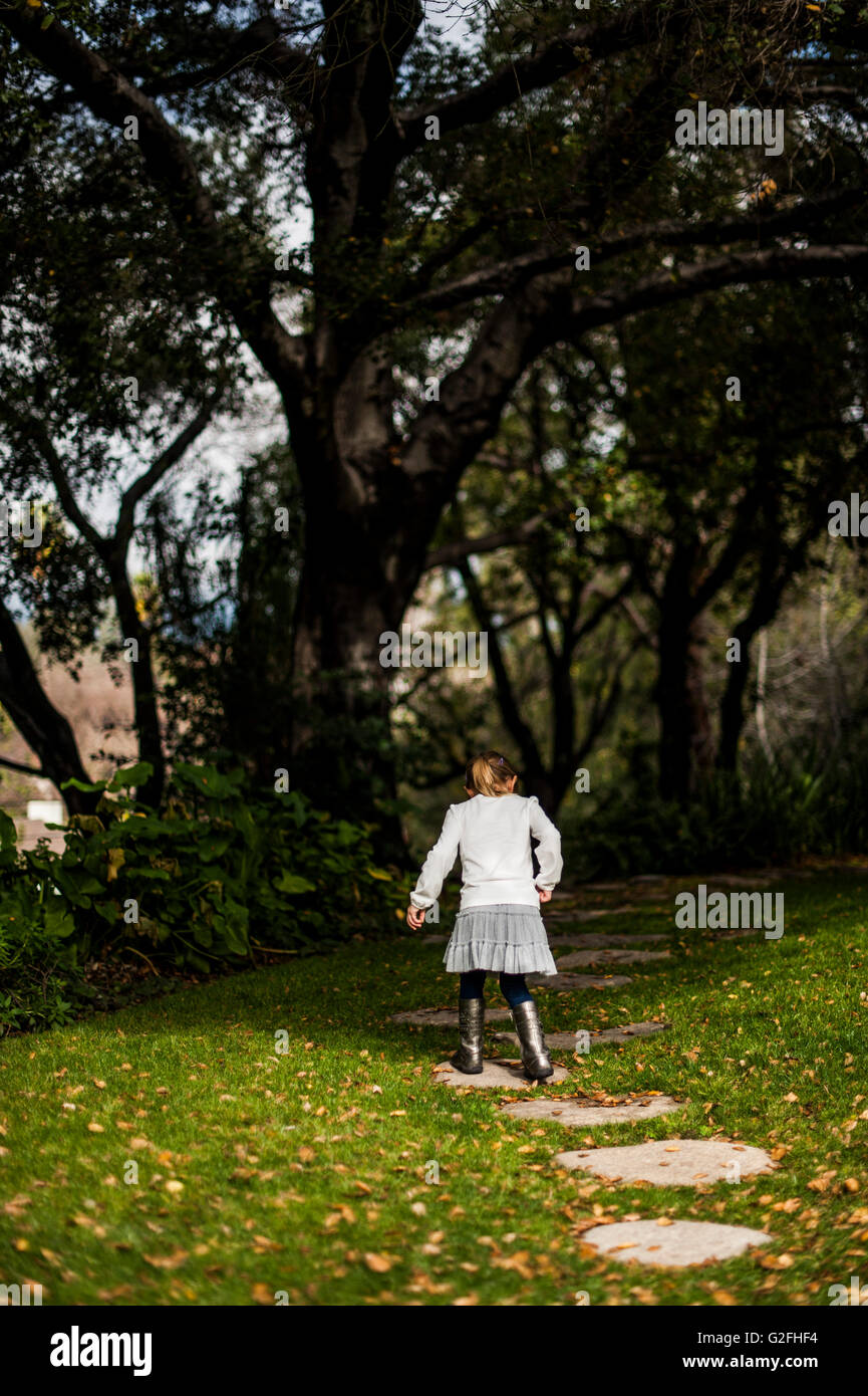 Young Girl Walking on Stepping Stones, Rear View Stock Photo - Alamy