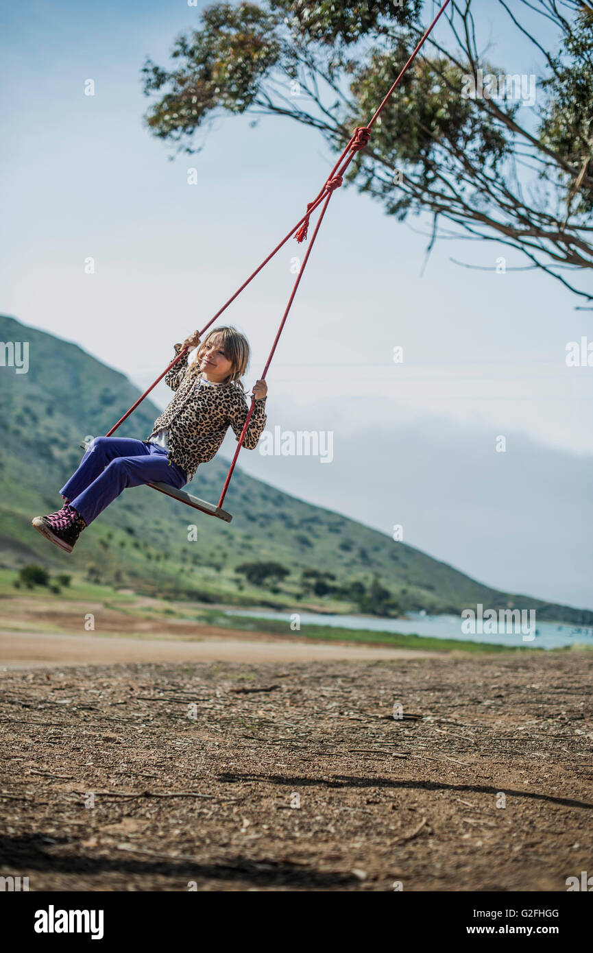 Girl swinging on tree hi-res stock photography and images - Alamy
