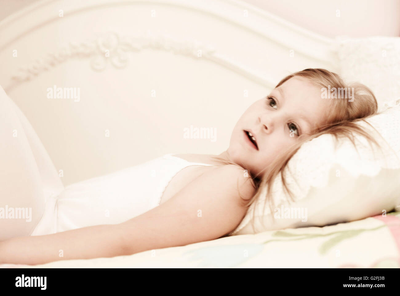 Young Girl Laying on Bed Stock Photo - Alamy