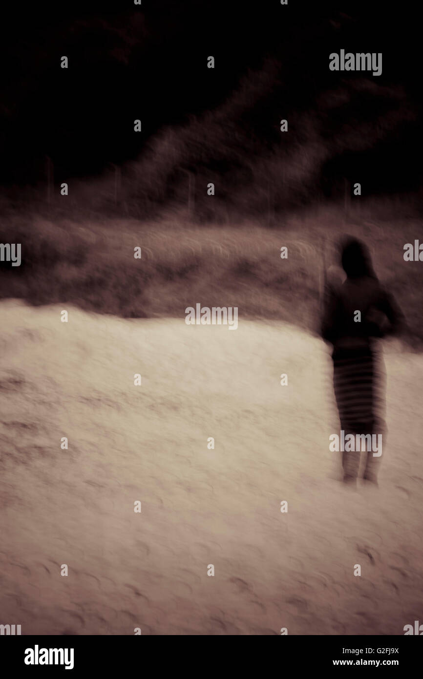 Blurred Woman Standing on Beach, Rear View Stock Photo - Alamy