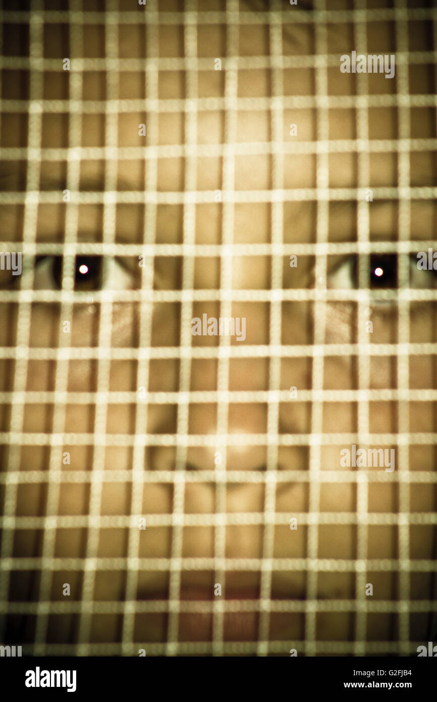 Young Boy's Face Behind Grid Stock Photo - Alamy