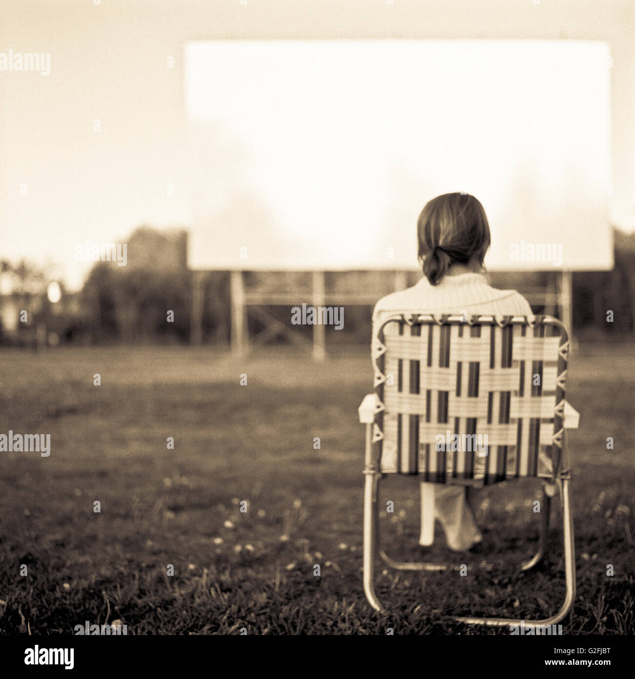 Woman Sitting on Lawn Chair in Field Stock Photo - Alamy
