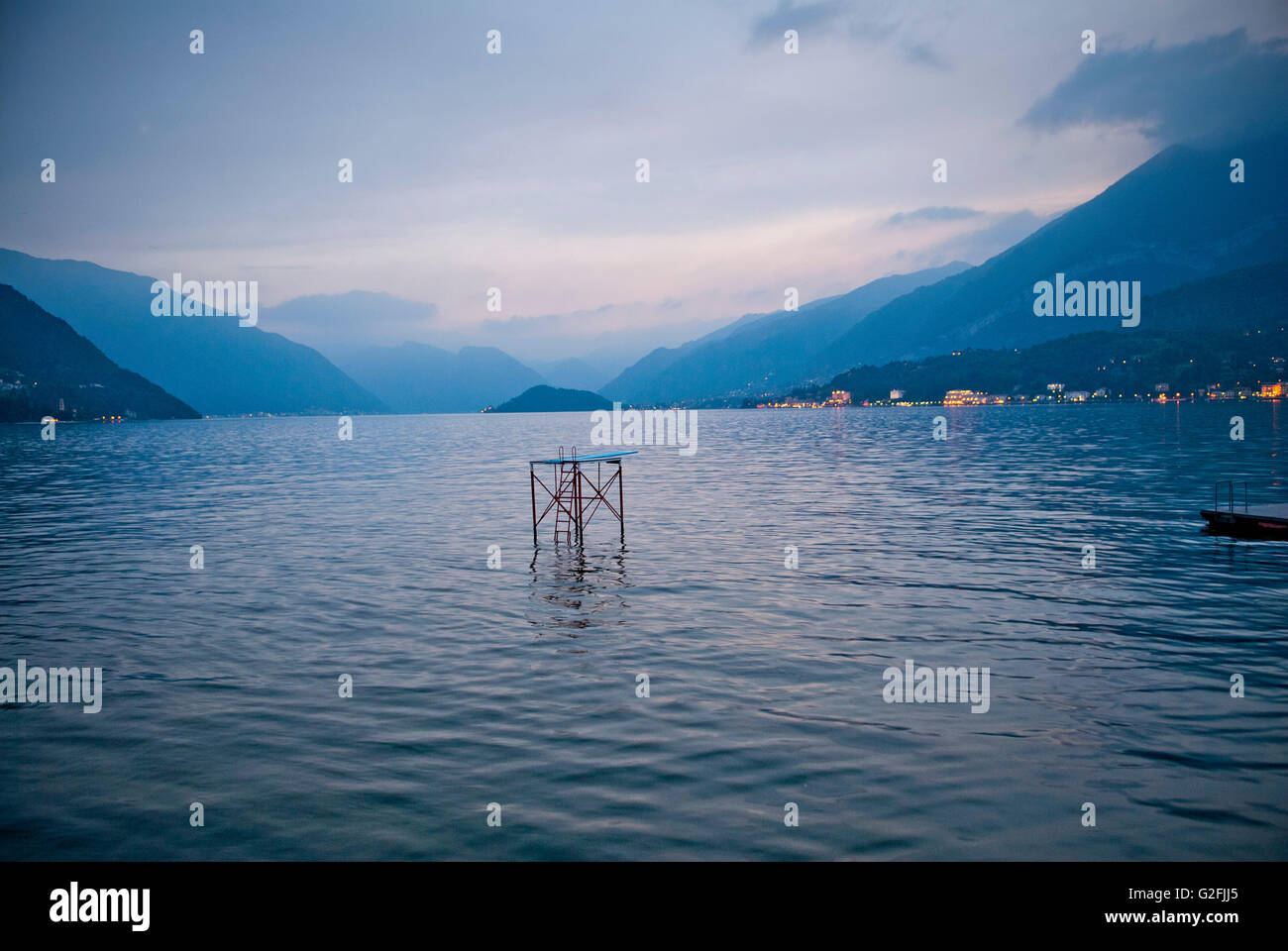 Diving Board and Platform in Middle of Lake at Sunset, Italy Stock ...