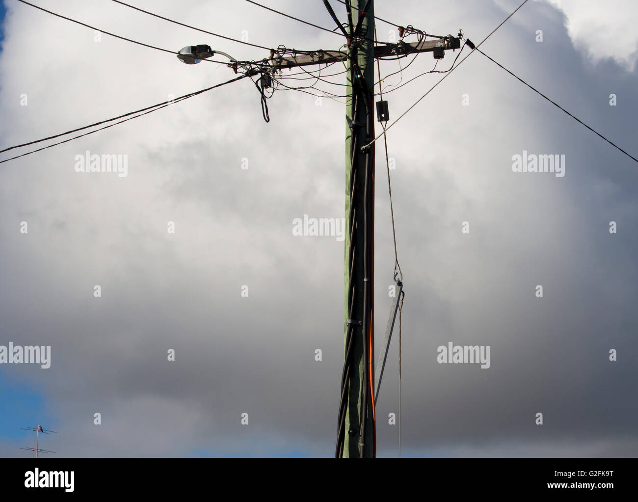 Suburban power lines and pole with fluffy white cumulus cloud ...