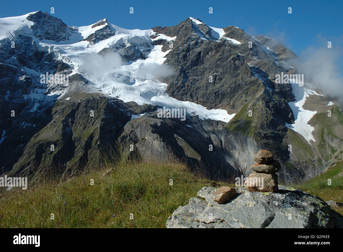 Stones on rock, peaks in snow and glacier nearby Grindelwald in Alps in ...