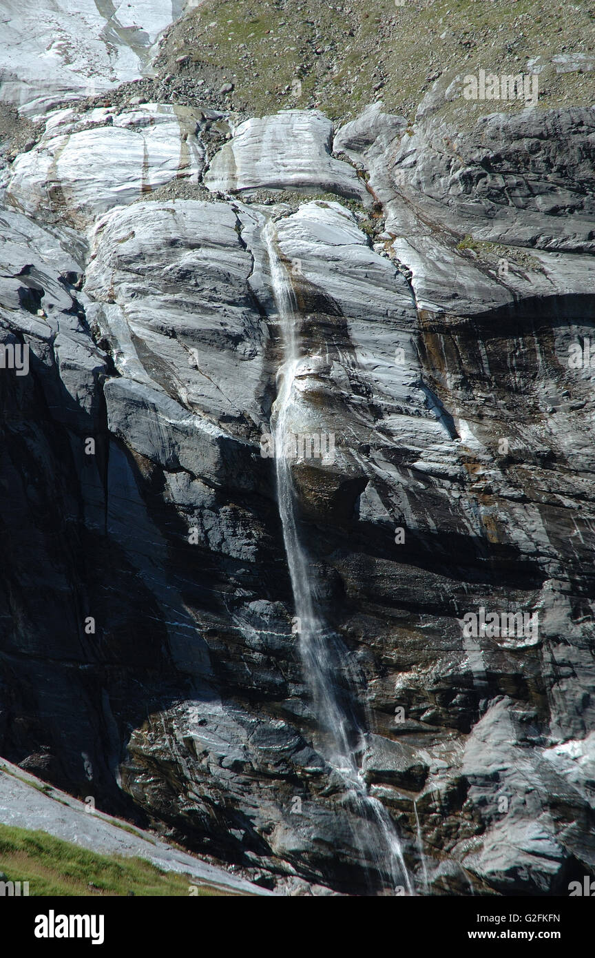 Waterfall in rocky valley nearby Grindelwald in Switzerland Stock Photo ...