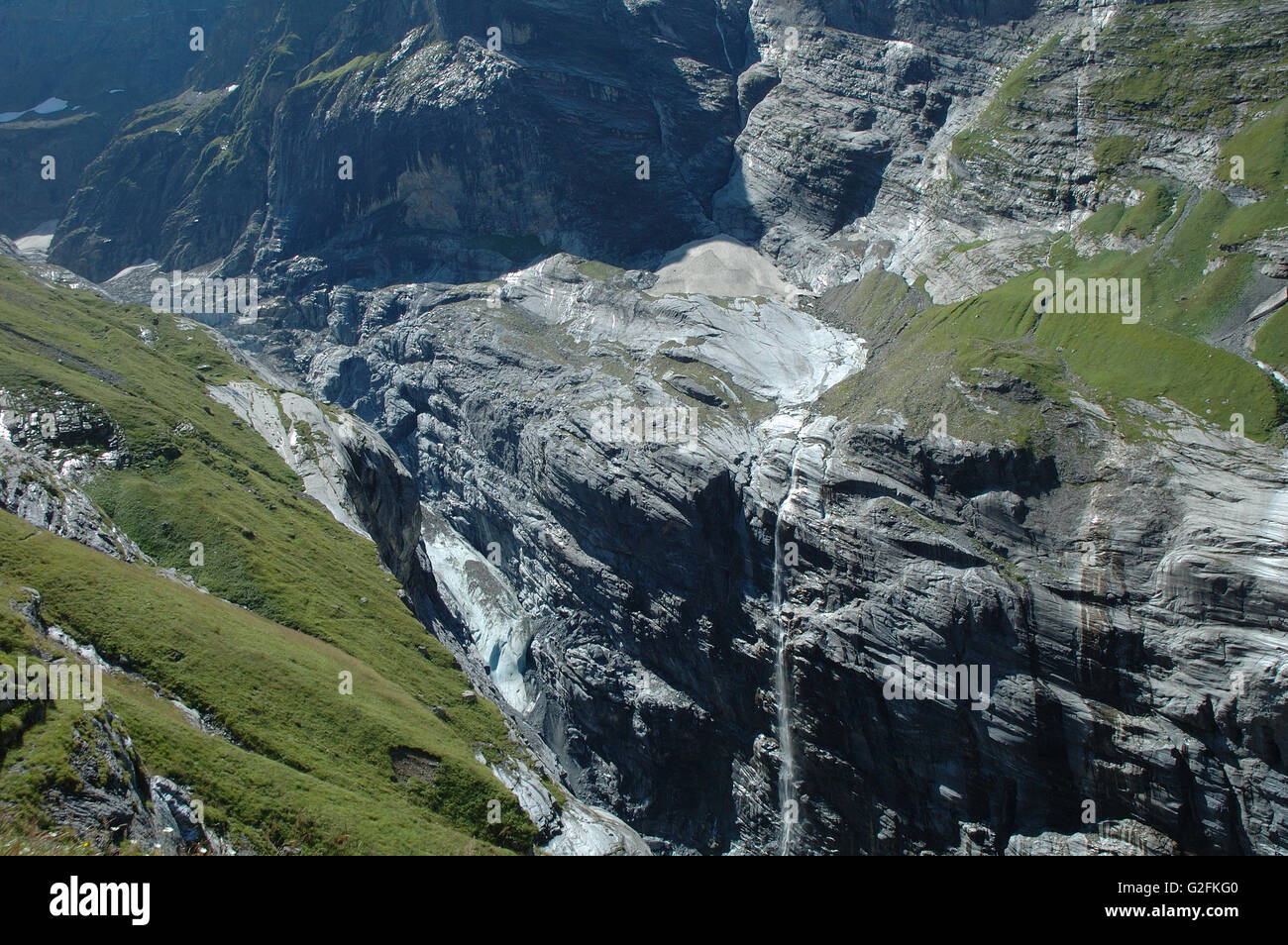 Glacier (Oberer Grindelwaldgletscher) and waterfall in rocky valley ...