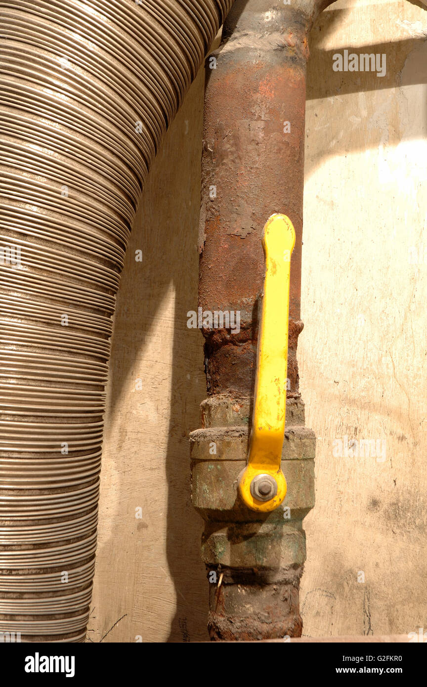 Old yellow valve and two pipes Stock Photo - Alamy