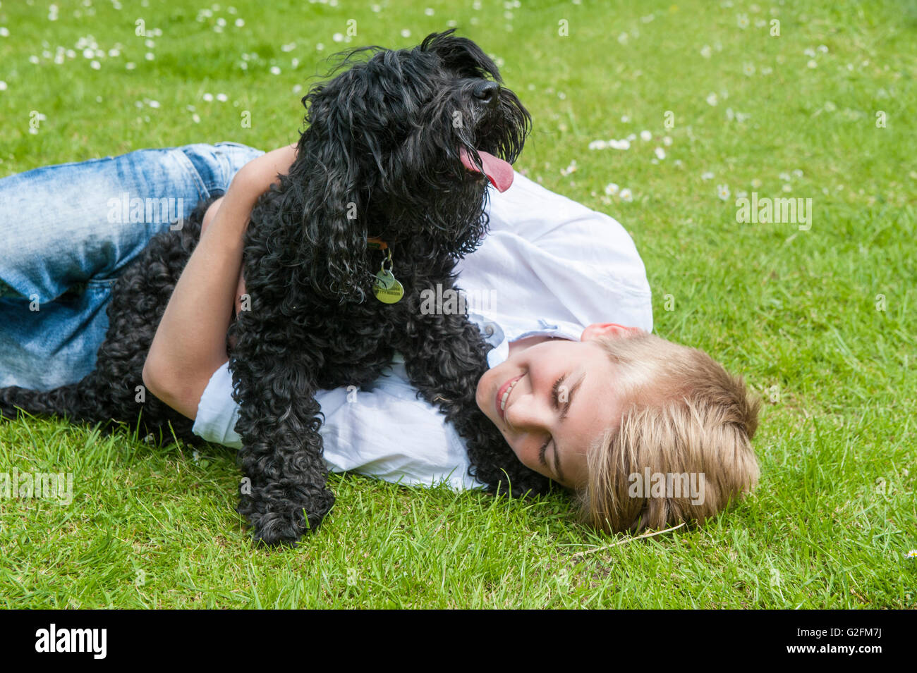 A young boy hugs his pet dog Stock Photo - Alamy