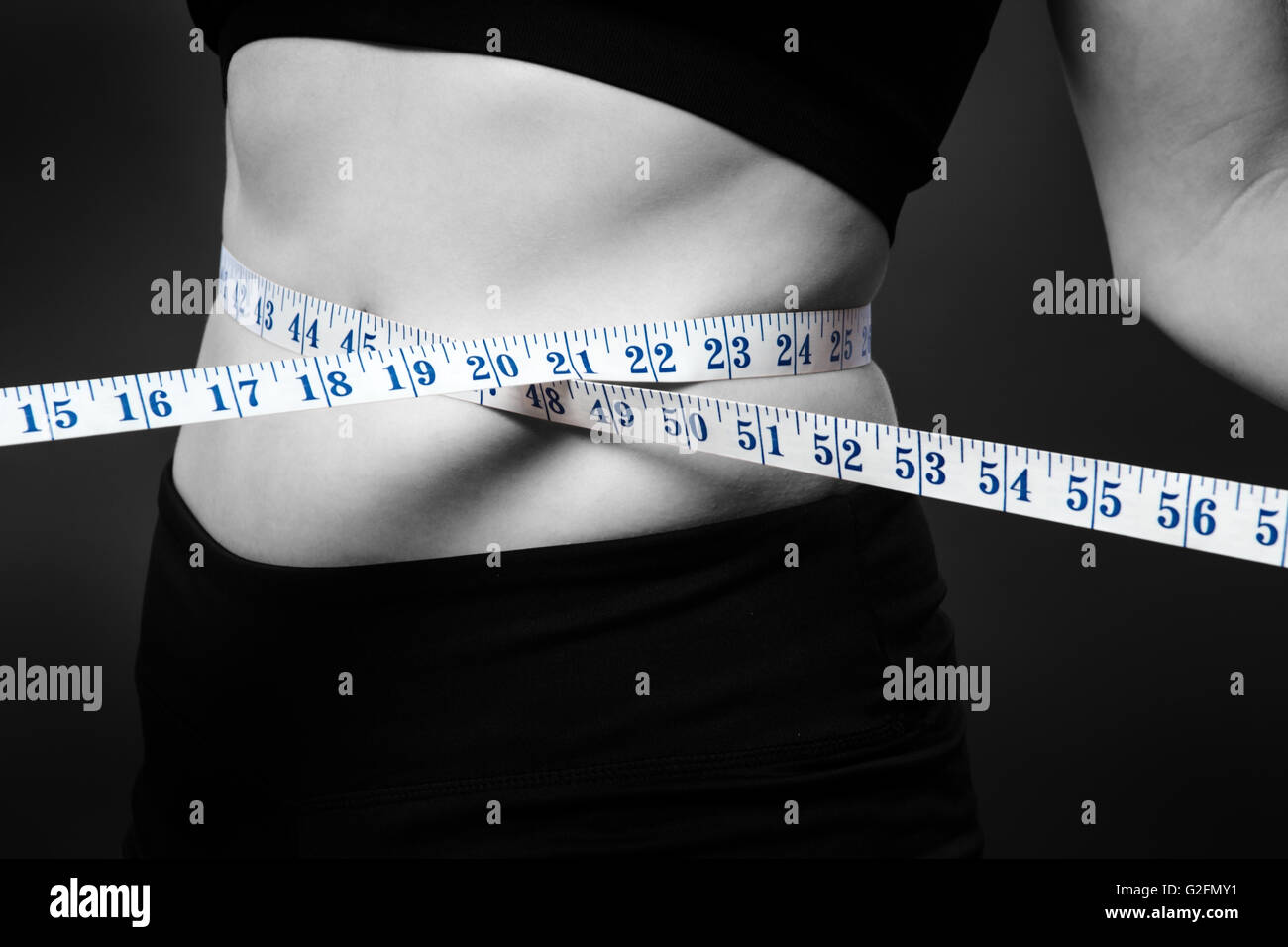 fitness woman with tape measure around her waist Stock Photo - Alamy