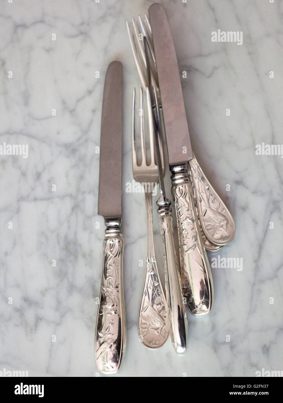 silver ware on marble table surface Stock Photo - Alamy