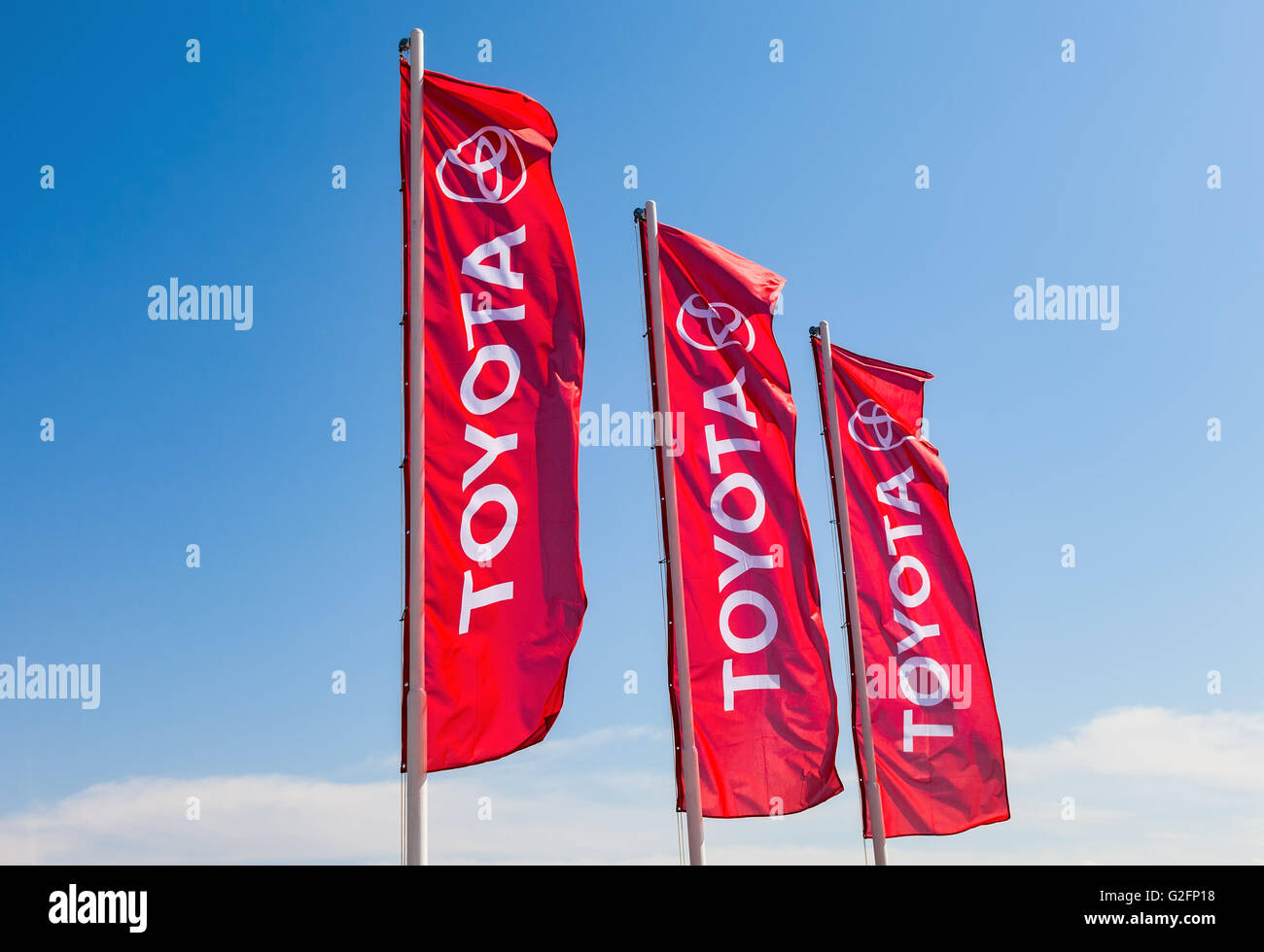 Official dealership flags of Toyota against the blue sky background ...