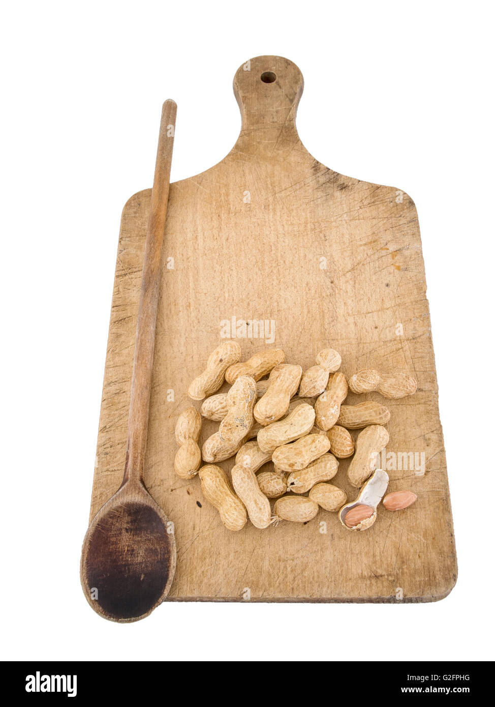 Monkey nuts aka peanuts in shells. Isolated on board with spoon. Forced ...