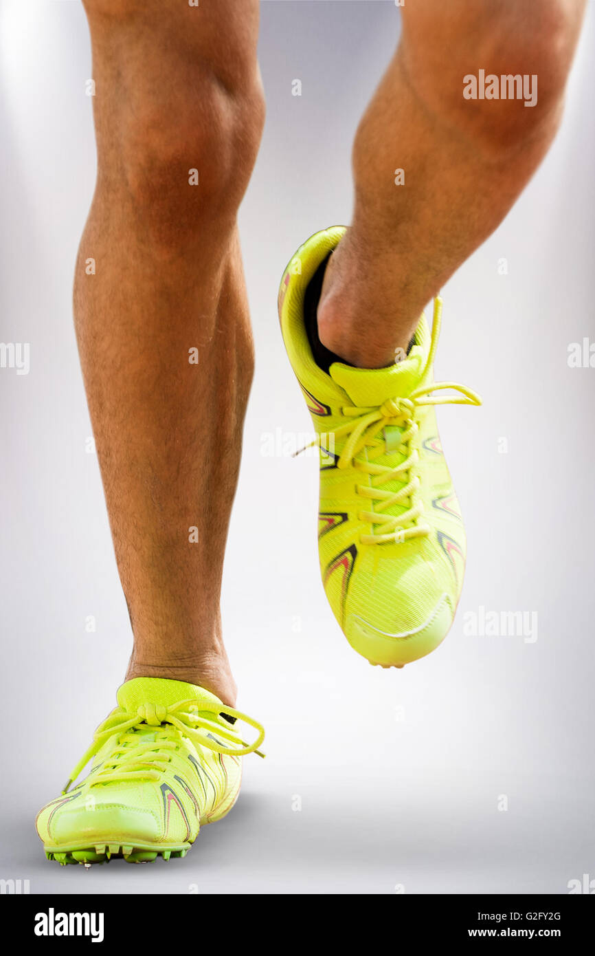 Composite image of close up of sportsman legs running on a white ...