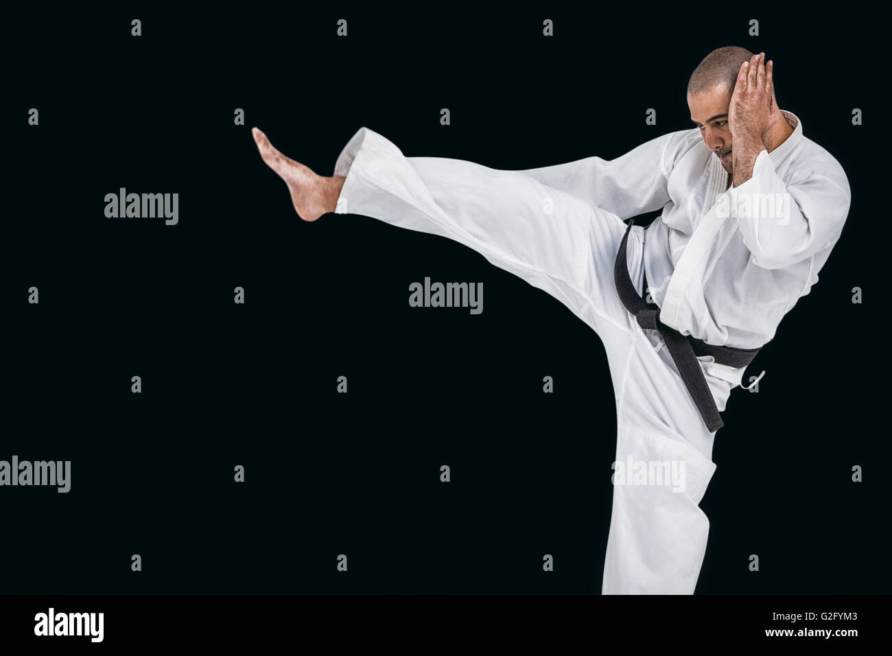 Composite image of fighter performing karate stance Stock Photo - Alamy