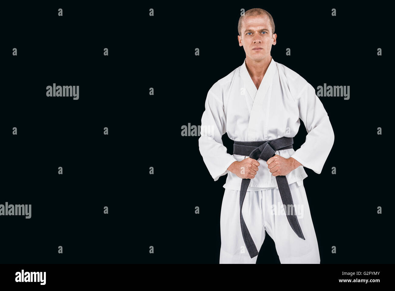 Composite image of fighter performing karate stance Stock Photo - Alamy