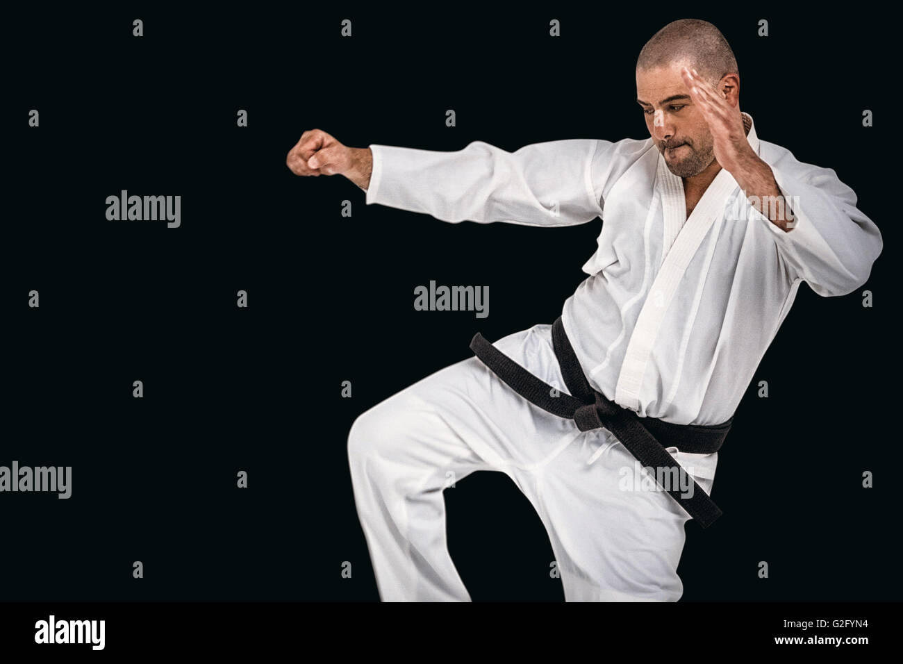 Composite image of fighter performing karate stance Stock Photo - Alamy