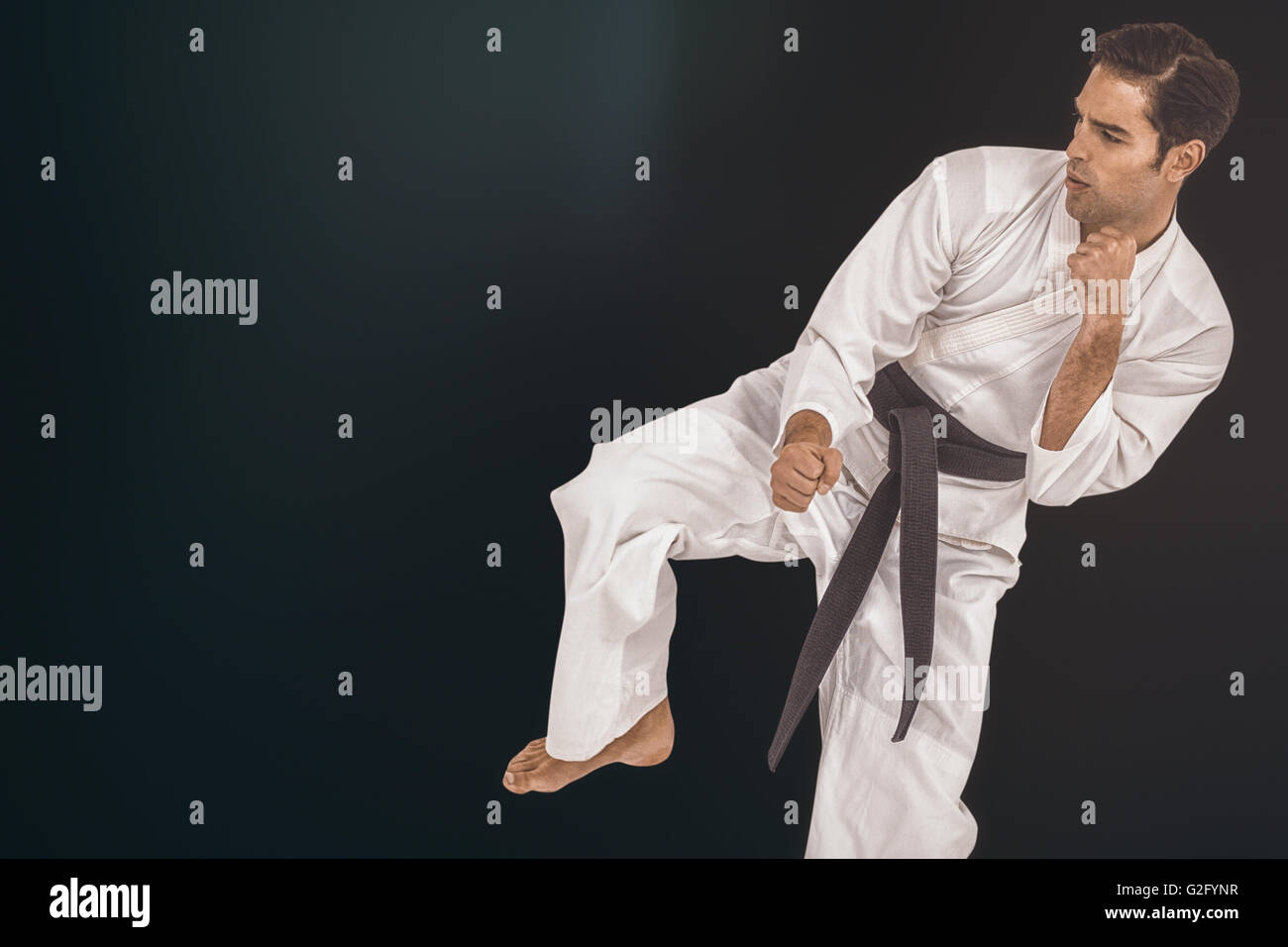 Composite image of fighter performing karate stance Stock Photo - Alamy