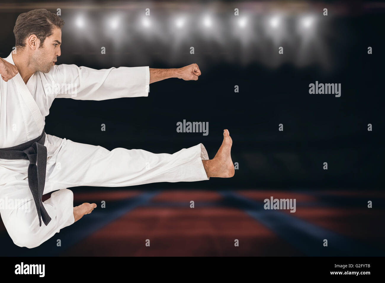 Composite image of fighter performing karate stance Stock Photo - Alamy