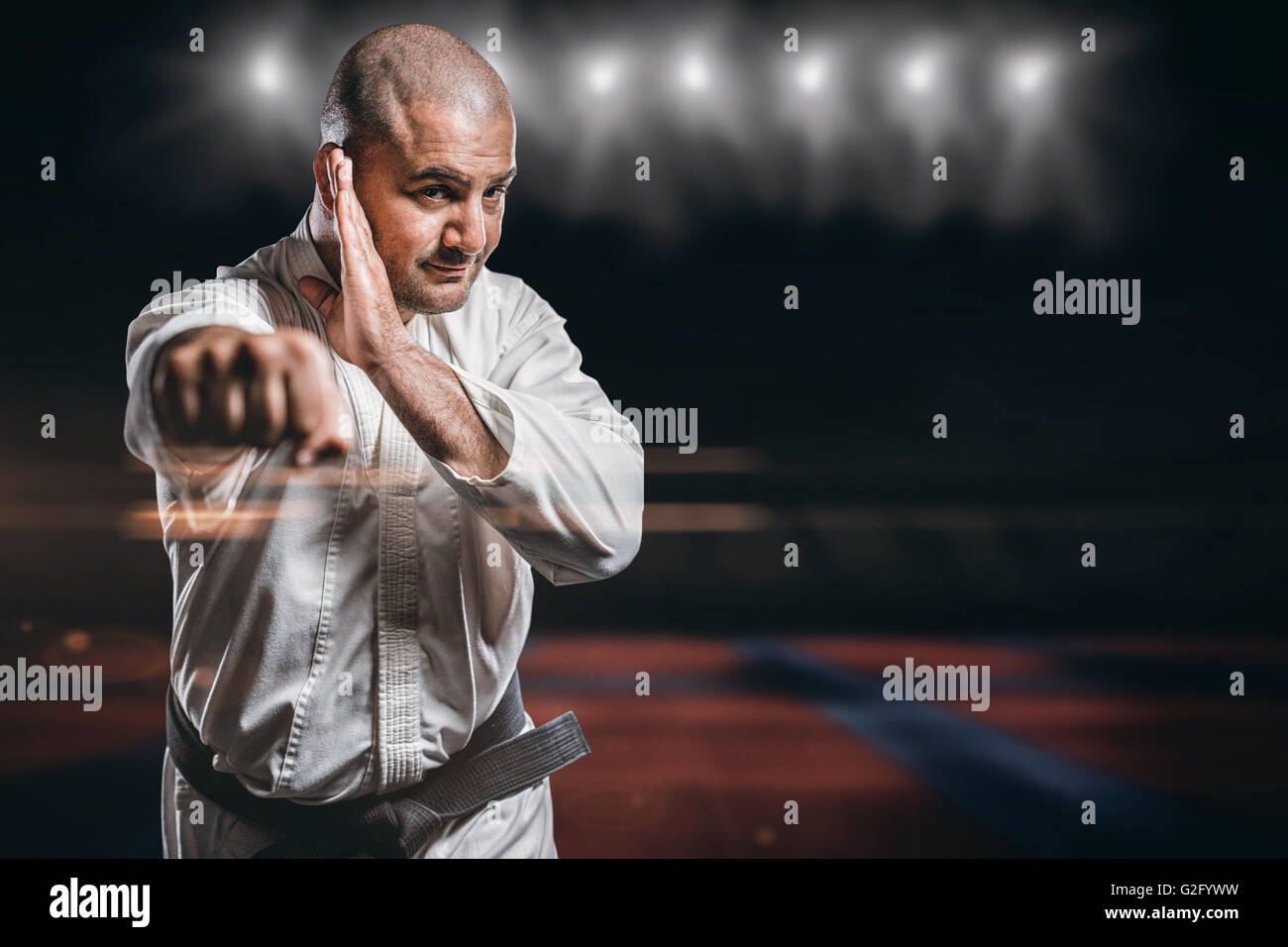 Composite image of fighter performing karate stance Stock Photo - Alamy