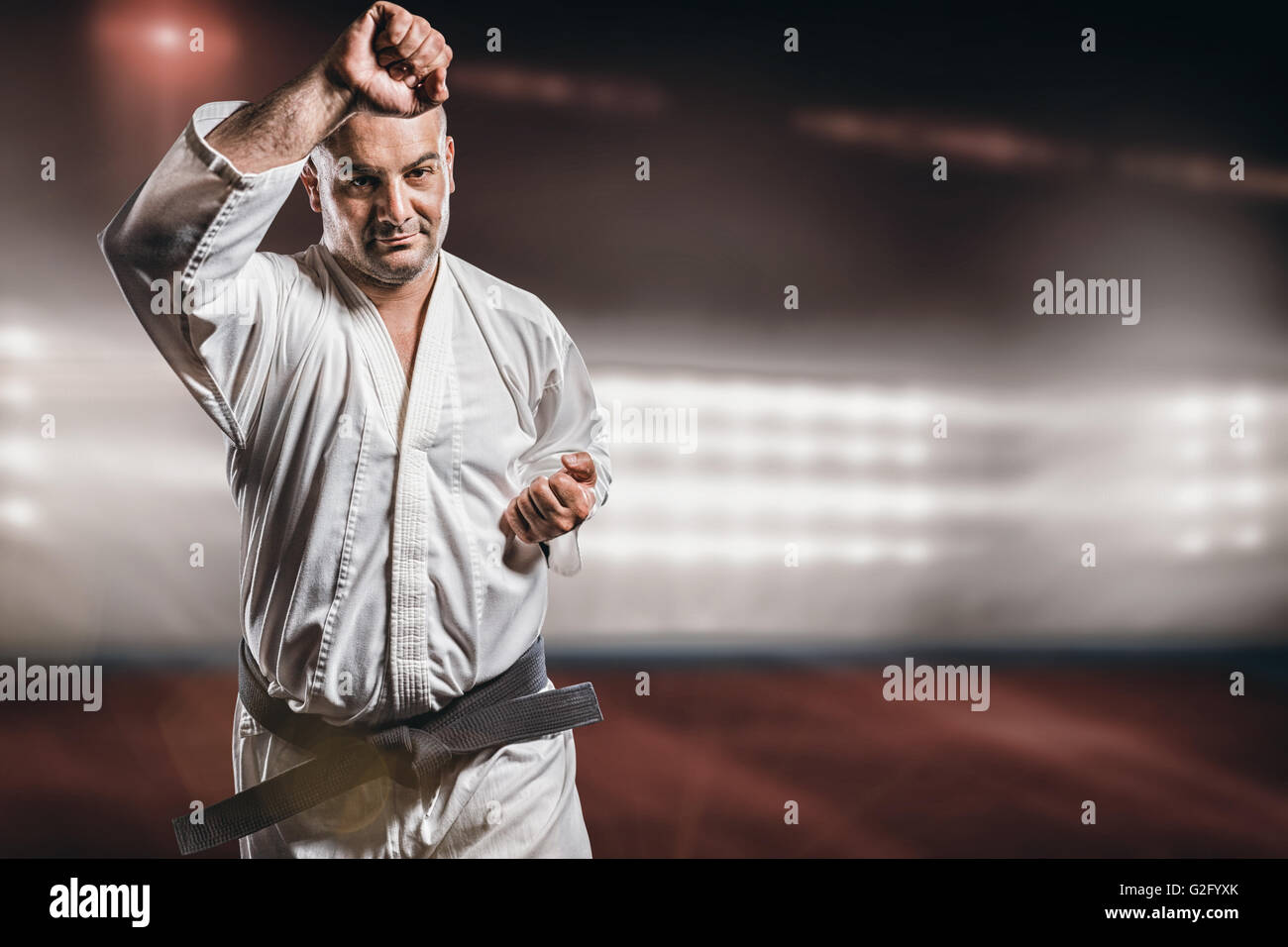 Composite image of fighter performing karate stance Stock Photo - Alamy