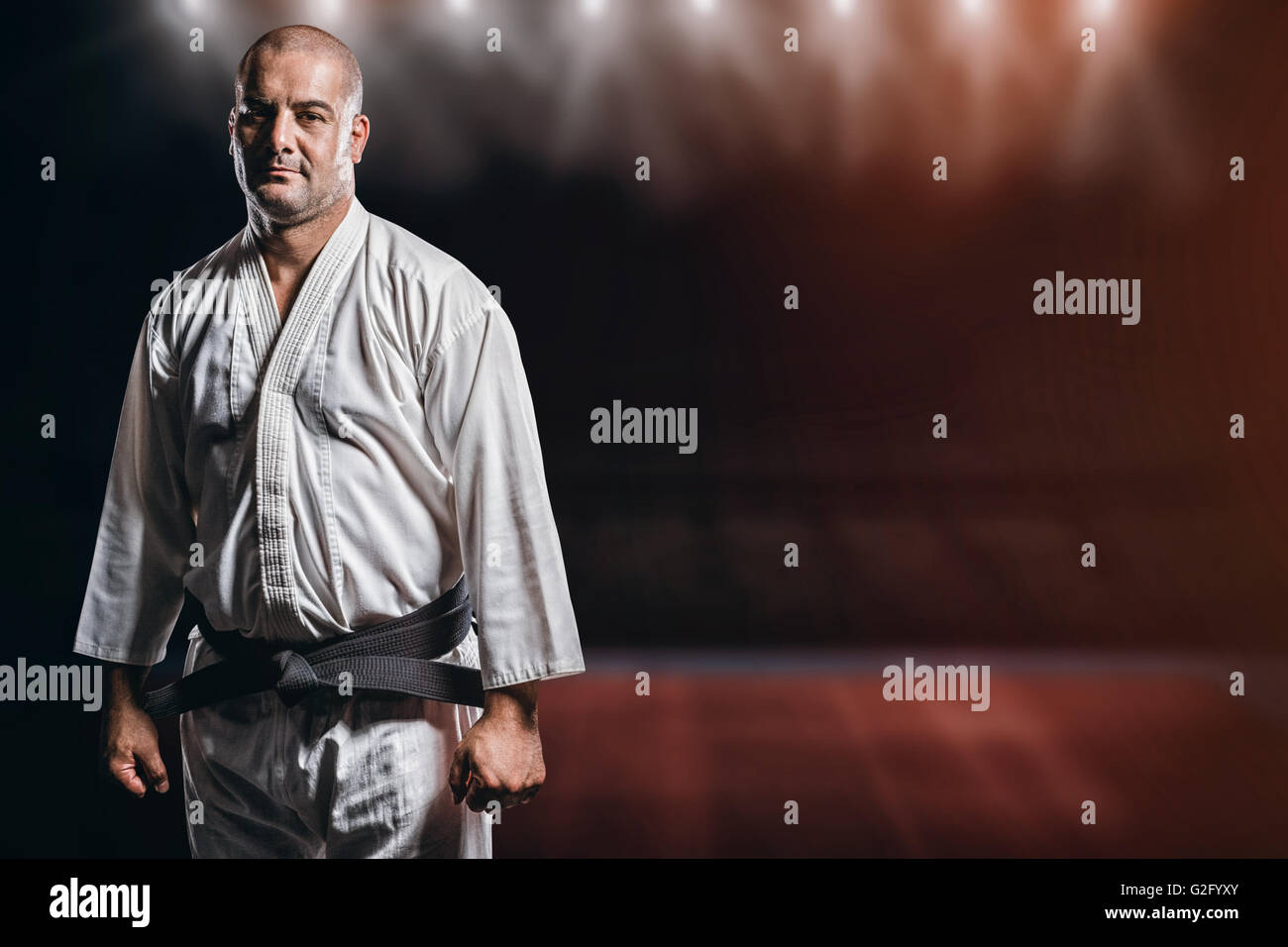 Composite image of confident fighter standing against black background ...