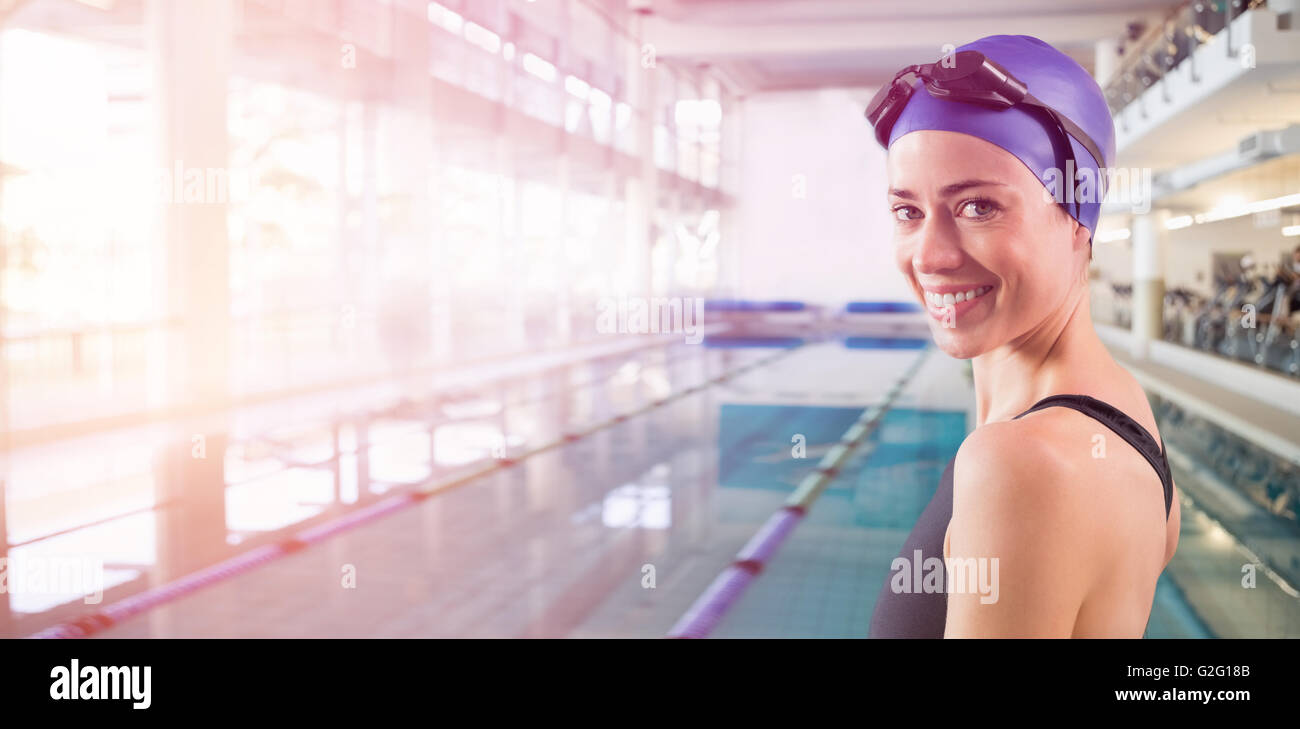 Fit swimmer standing by the pool smiling at camera Stock Photo - Alamy