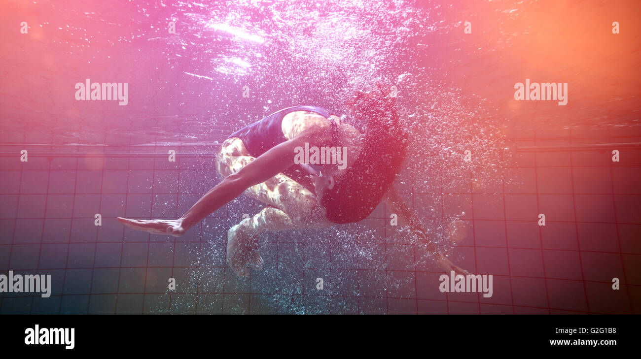 Athletic swimmer doing a somersault underwater Stock Photo - Alamy