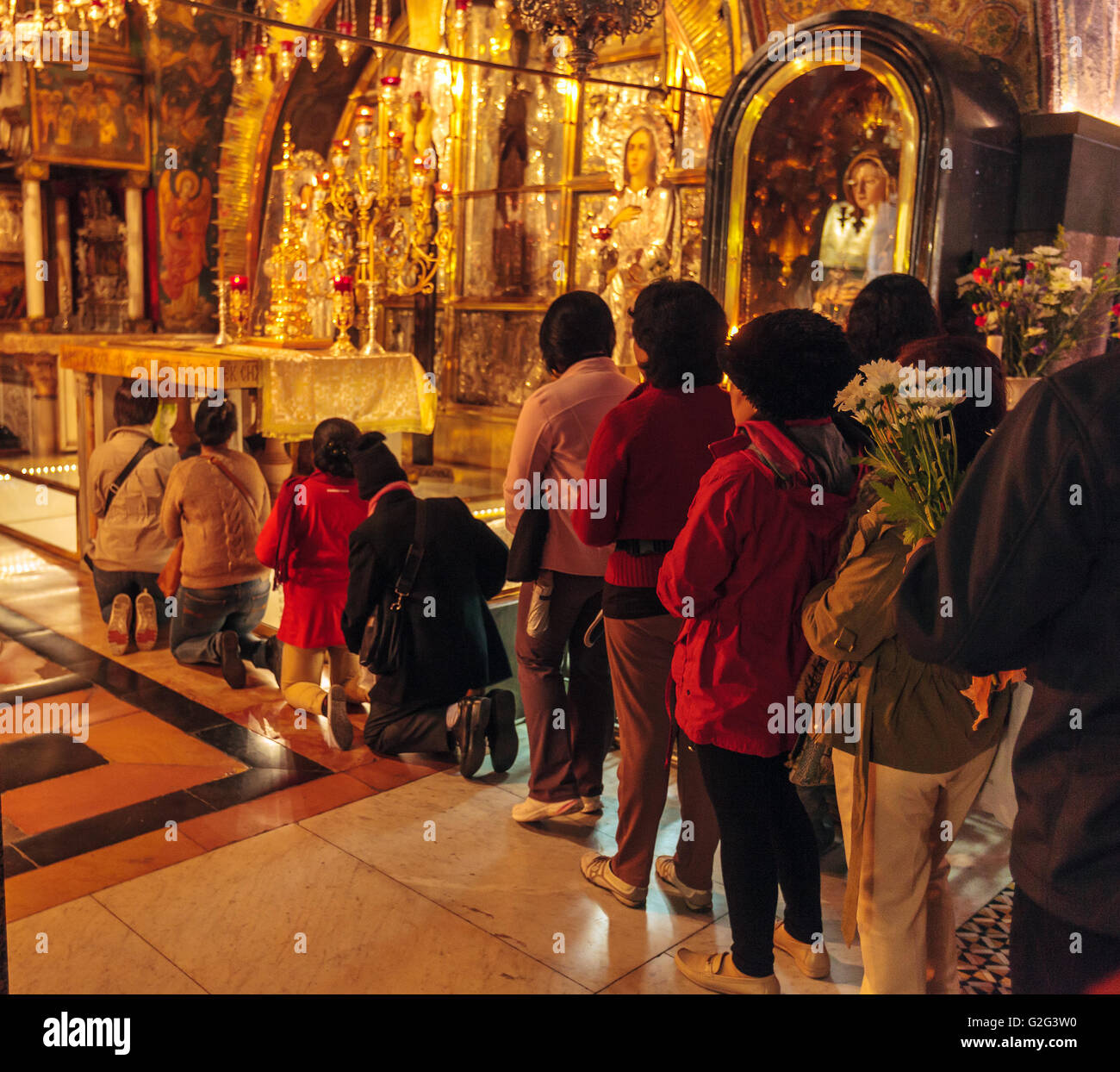 JERUSALEM, ISRAEL - FEBRUARY 17, 2013: Pilgrims praying near Golgotha ...