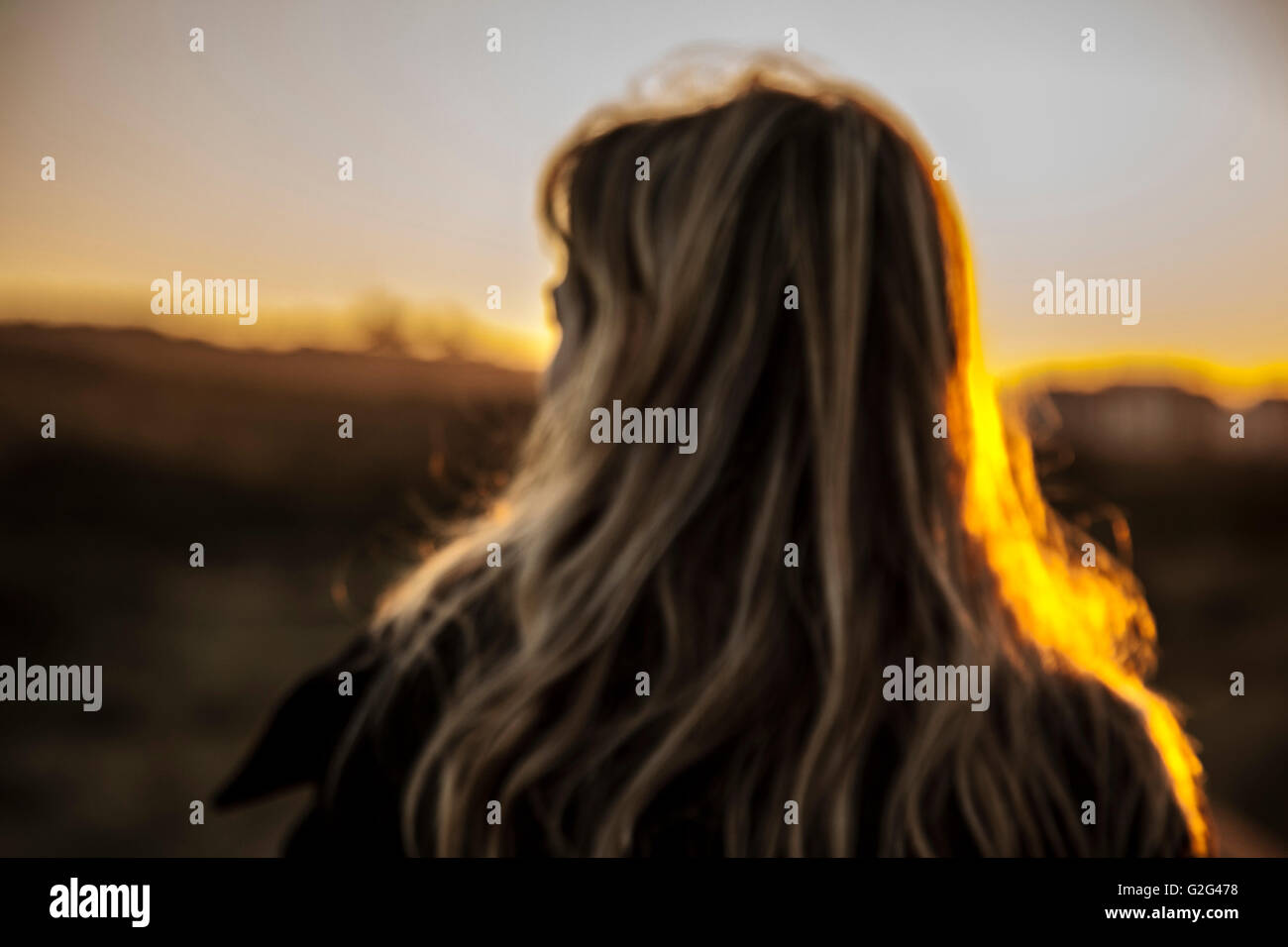 Rear View of Woman Watching Sunset Stock Photo - Alamy