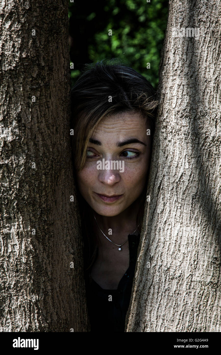 Woman's Head Between Two Tree Trunks Stock Photo - Alamy