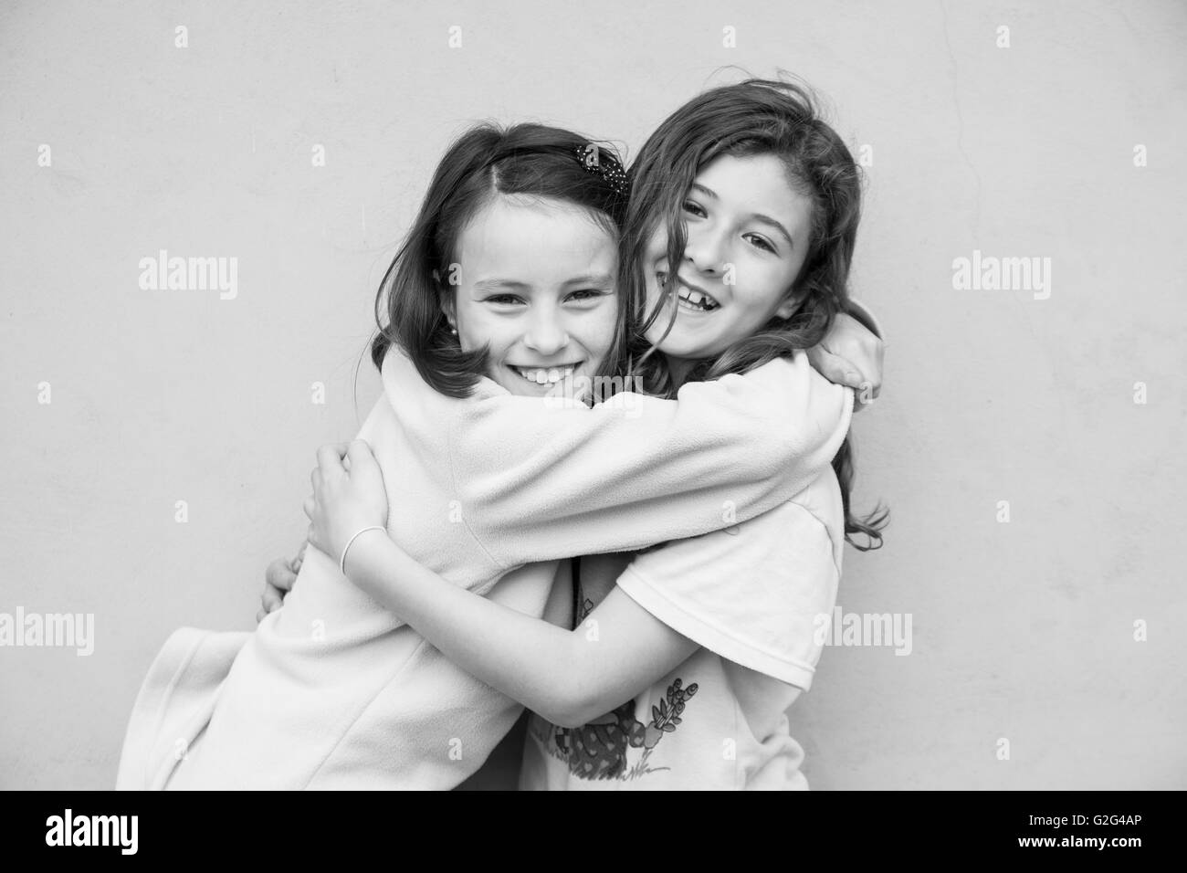 Two Smiling Young Girls Hugging Stock Photo - Alamy