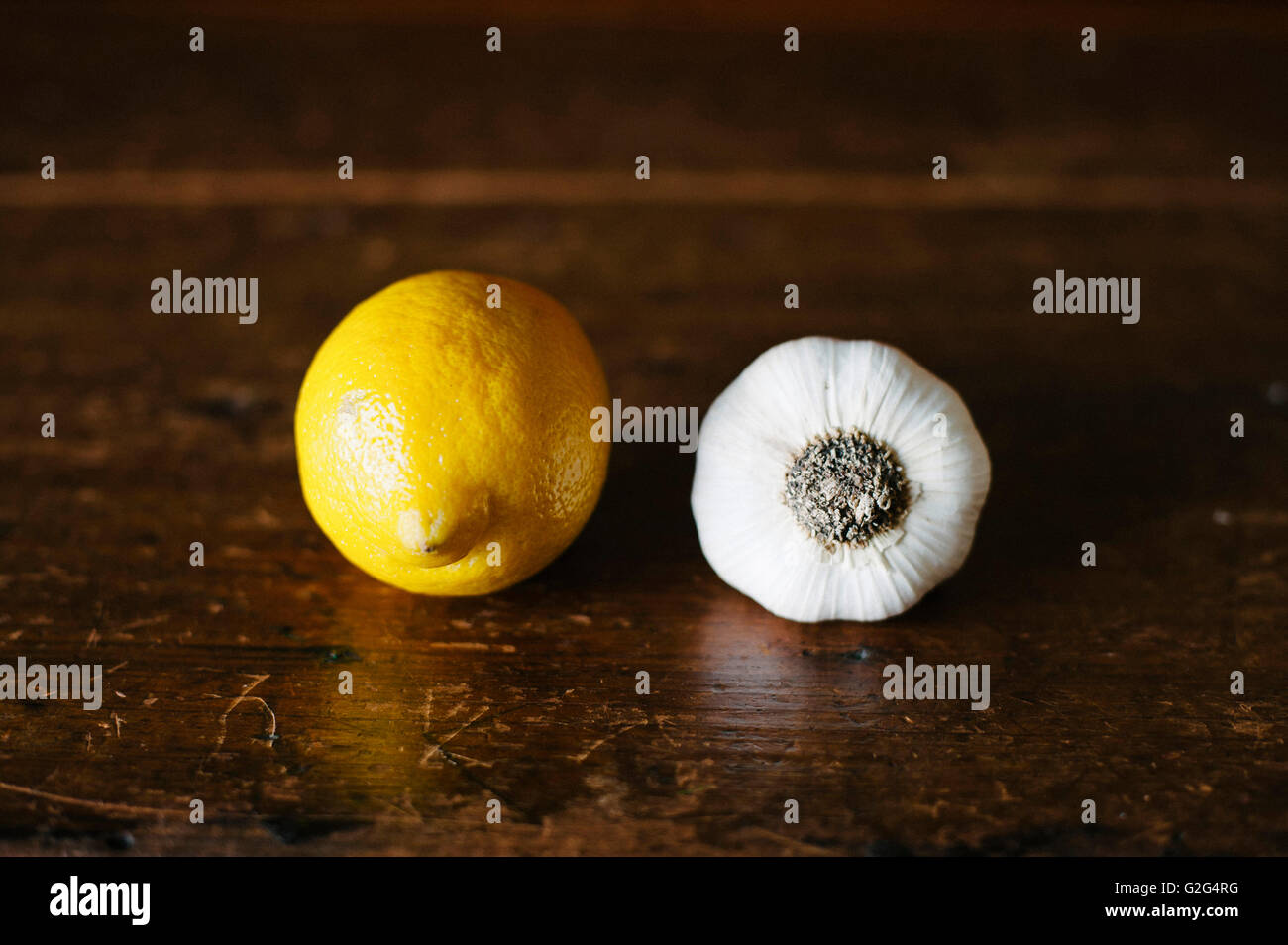 Lemon and Garlic on Wood Table Stock Photo - Alamy