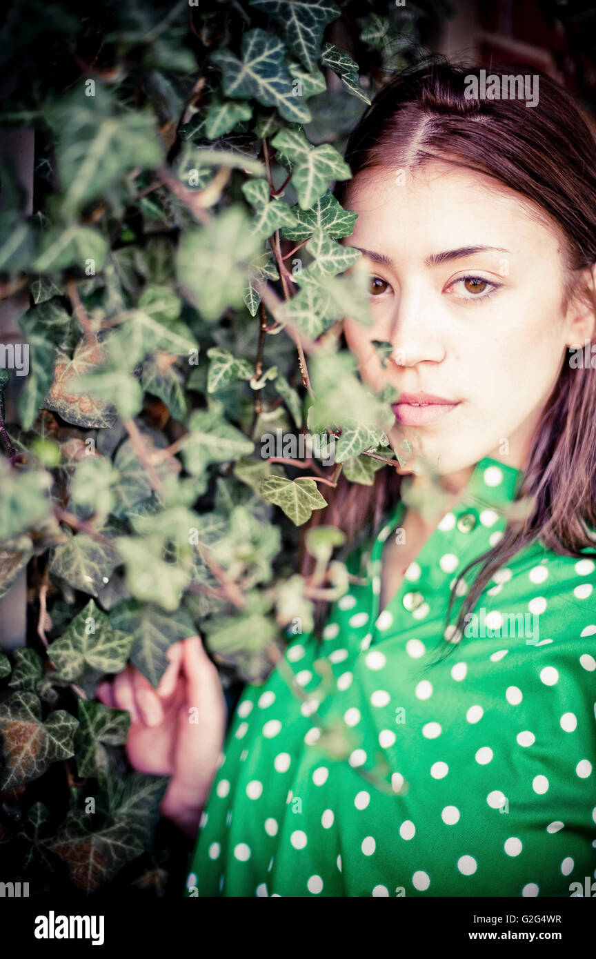 Portrait young woman peering through hi-res stock photography and ...