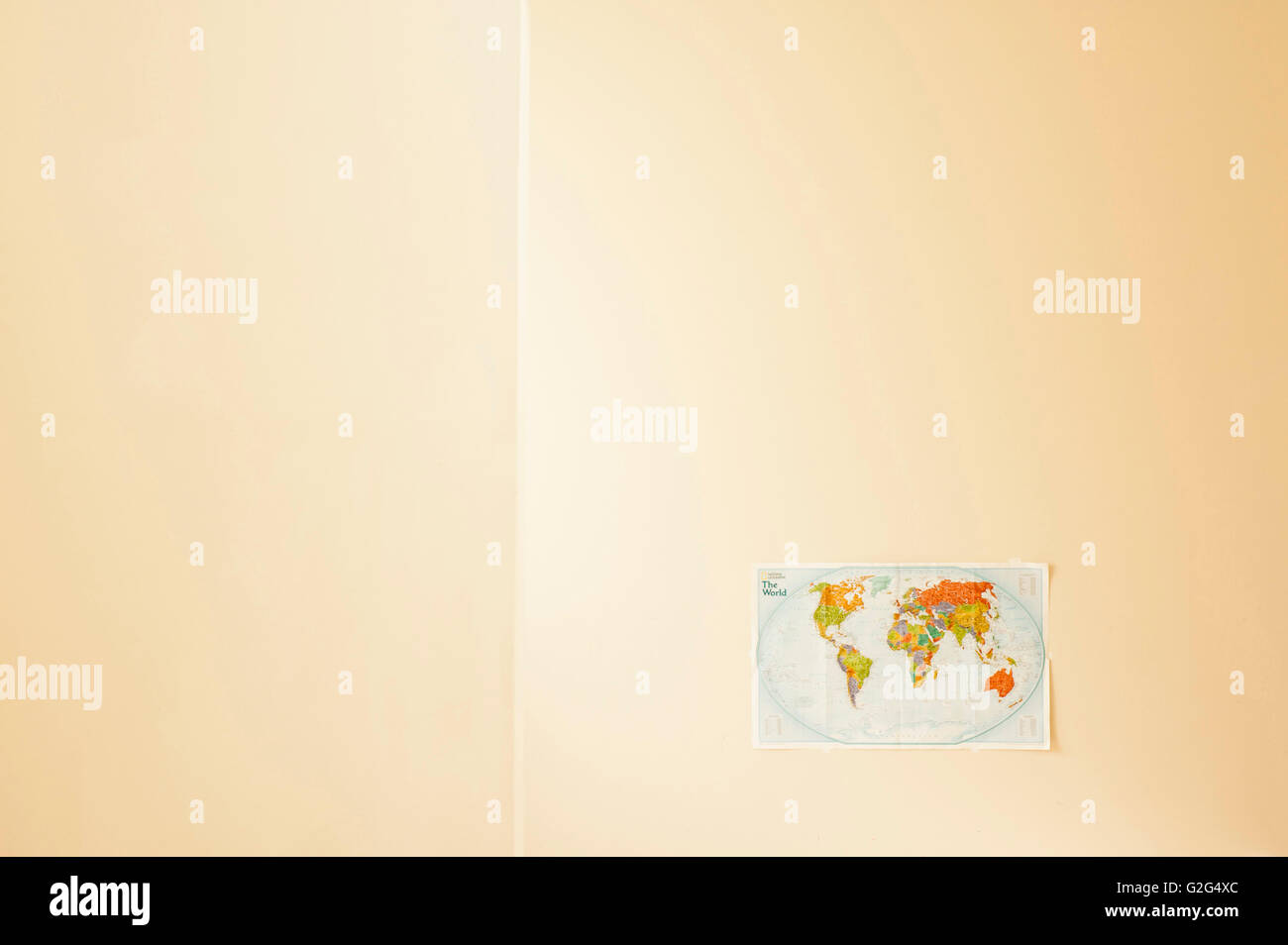World Map Pinned to Bare Wall Stock Photo - Alamy