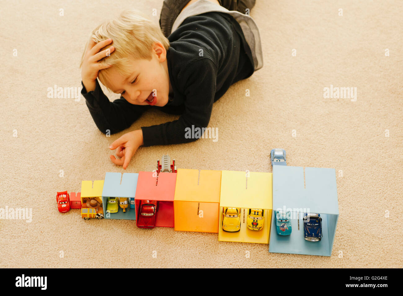Young Boy Playing with Boxes and Toy Cars Stock Photo - Alamy