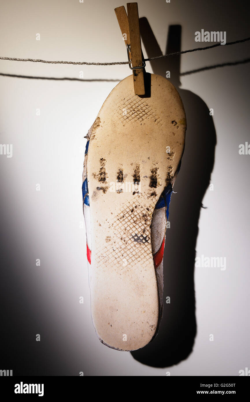 Old Sneaker Clothespinned to Line, Rubber Sole Exposed Stock Photo - Alamy