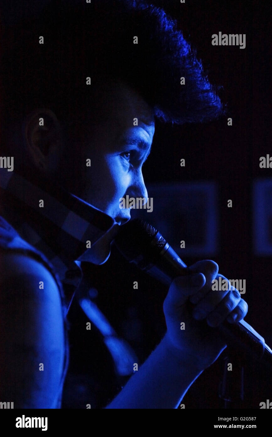 Male Punk Musician With Mohawk Singing into Microphone Stock Photo - Alamy