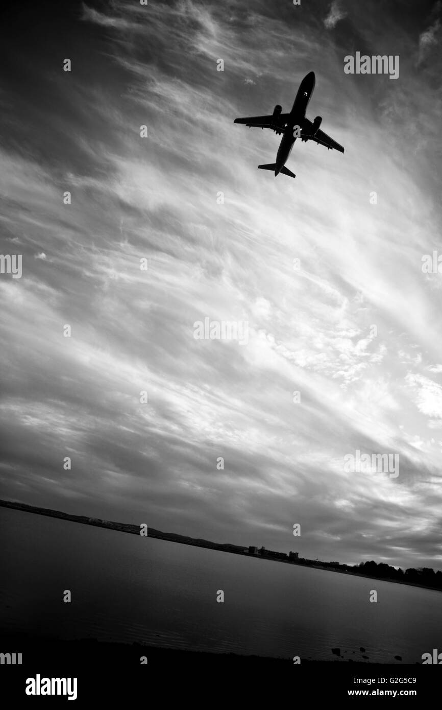 Airplane Flying by Dramatic Sky Stock Photo - Alamy