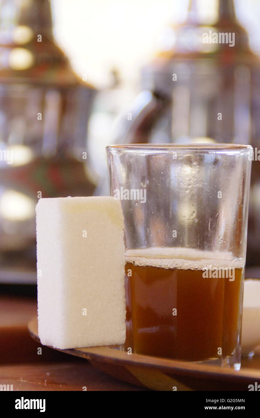 a shot of tea and a lump of sugar Stock Photo - Alamy