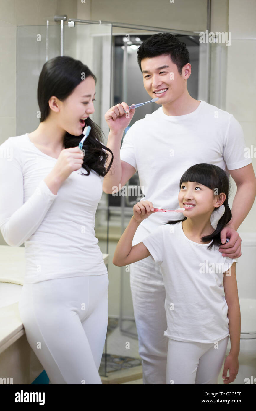 Happy young family brushing teeth Stock Photo - Alamy
