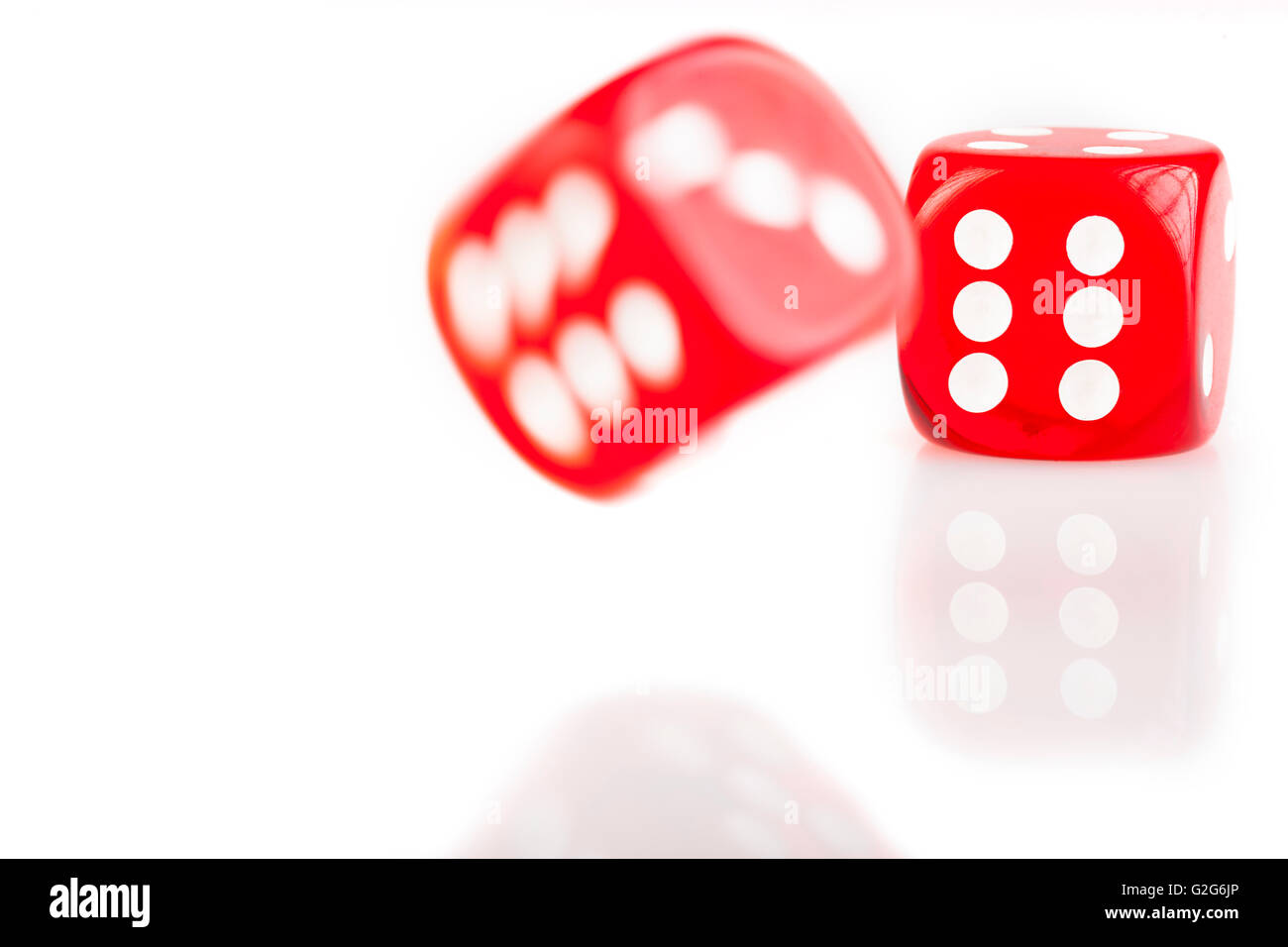 Pair of bouncing red dice isolated on white background with reflection ...